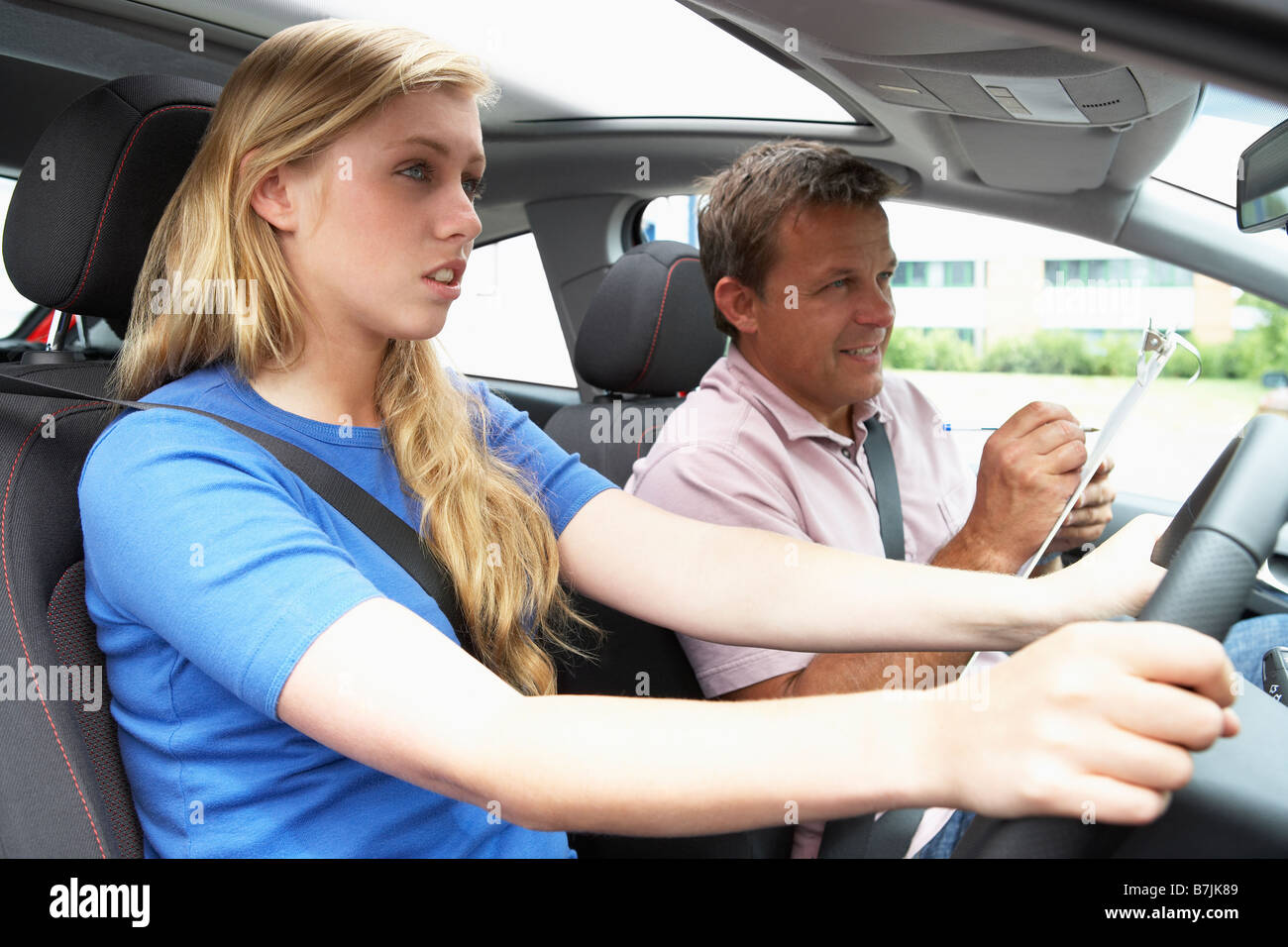 Teenage Girl Taking A Driving Lesson Stock Photo - Alamy