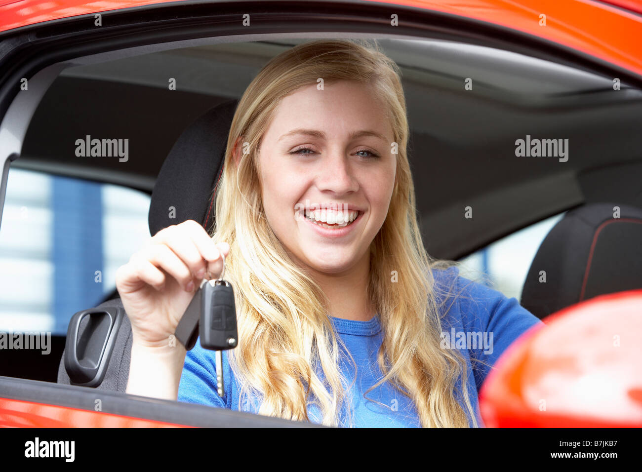 Teenage Girl Sitting In Car, Holding Car Keys And Smiling At The Camera ...