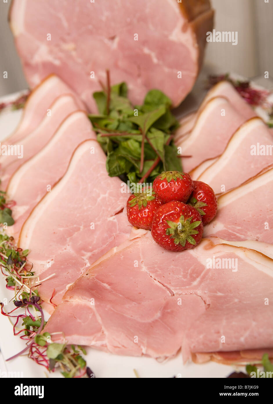 Sliced ham with strawberry garnish Stock Photo - Alamy