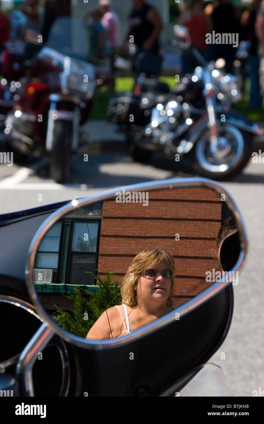 Woman's reflection in the side mirror of her motorcycle, motorcycle ...