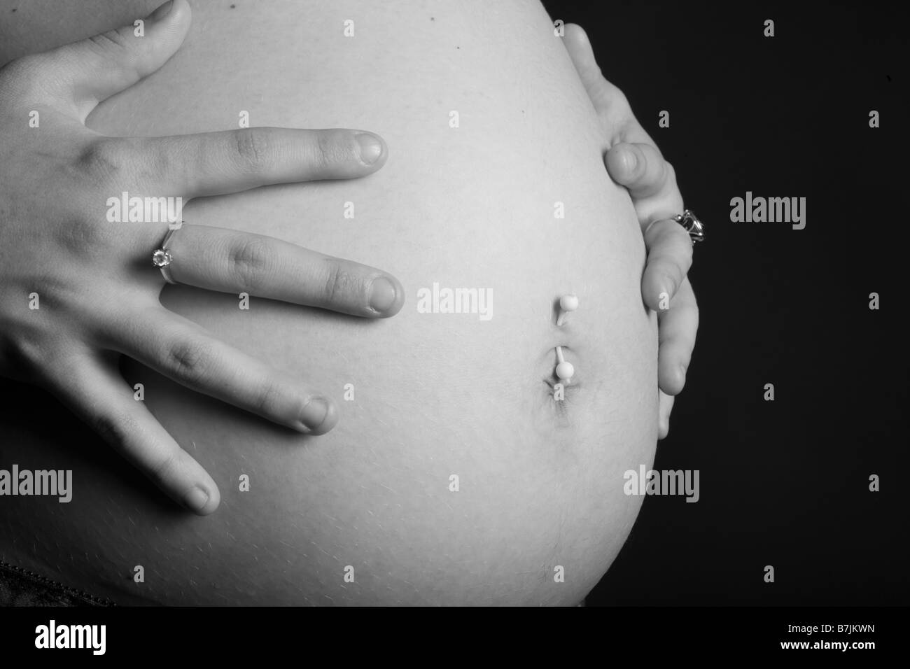 Belly with hands Stock Photo - Alamy