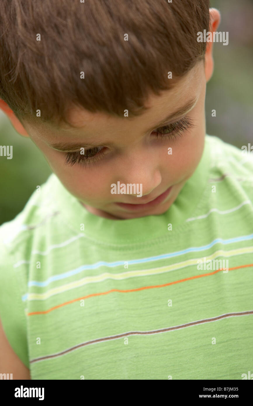 Portrait Of Young Boy Looking Down Stock Photo - Alamy