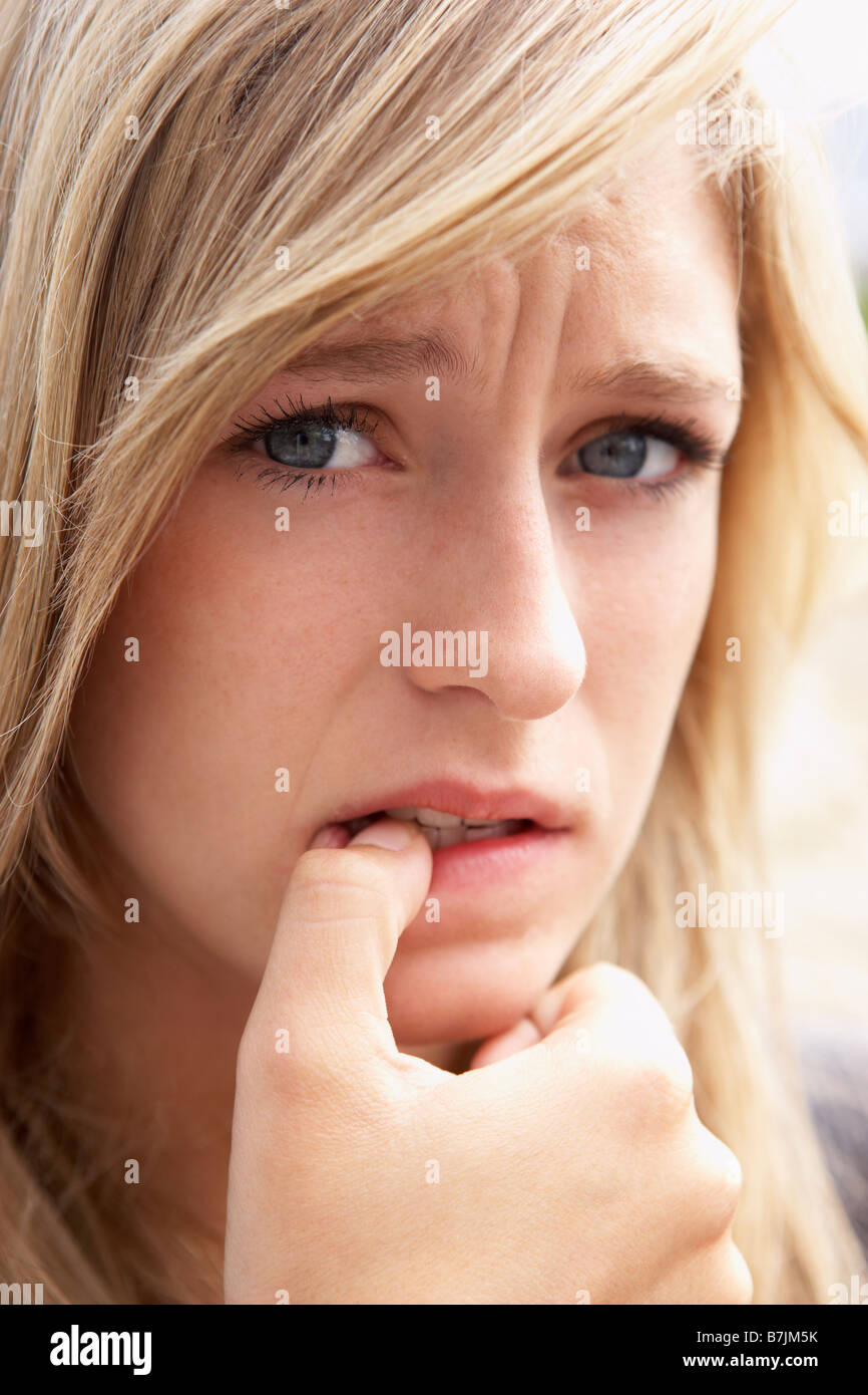 Portrait Of Girl Biting Nails Stock Photo - Alamy