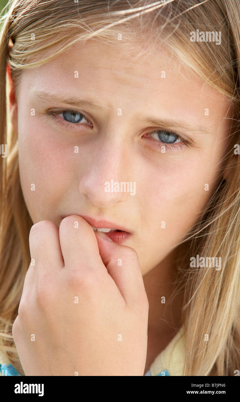 Portrait Of Girl Biting Nails Stock Photo - Alamy
