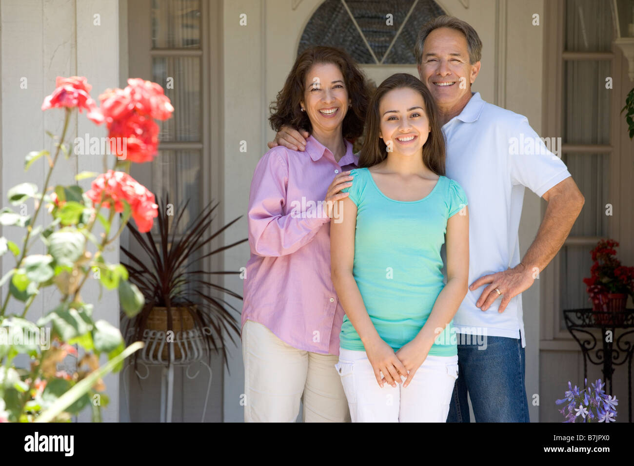 Family Standing Outside House Stock Photo - Alamy