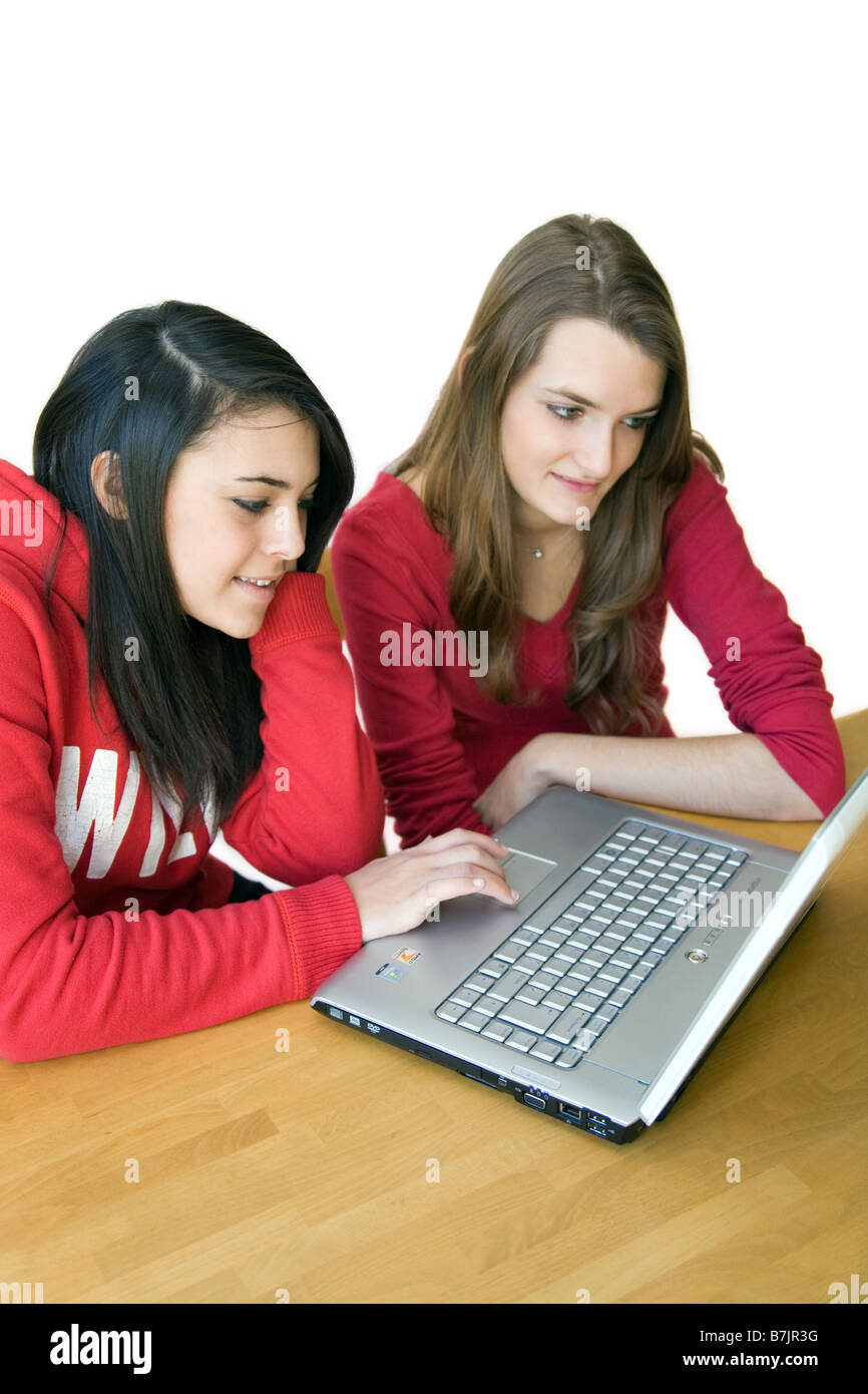 Two teenage girls doing their homework on a laptop computer Stock Photo ...