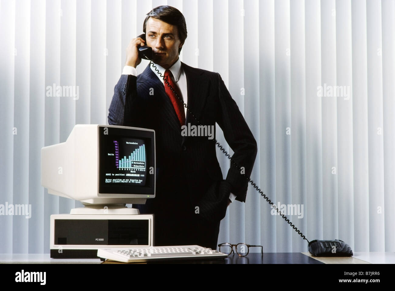 Executives at work in office setting with computer Stock Photo - Alamy