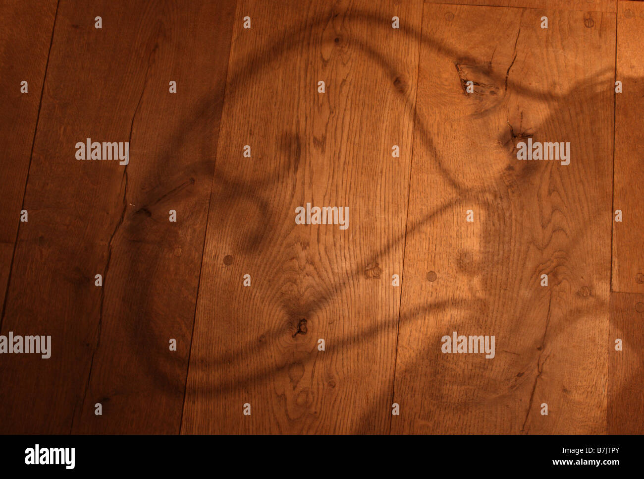 Heart shadow on oak floor Stock Photo - Alamy