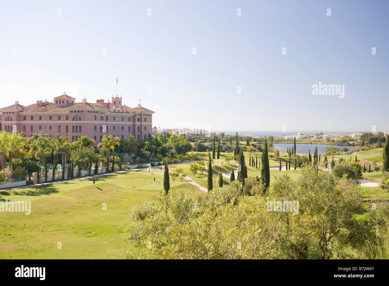 Golf course with hotel in background and palm fringed driveway Stock ...