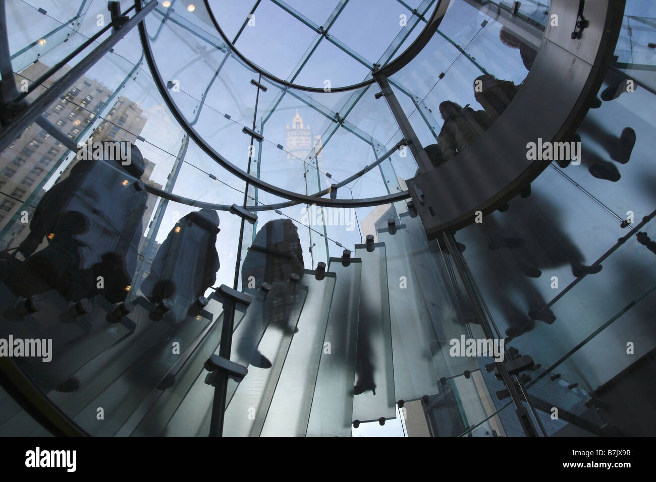 Customers walking up and down the glass steps at the Apple Store on ...