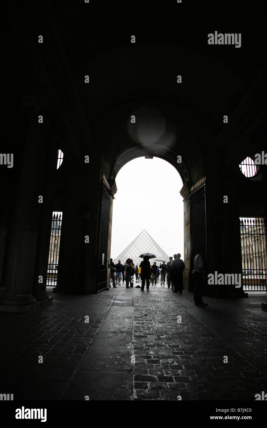 Rain upon tourists at The Louvre Paris with pyramid Stock Photo - Alamy