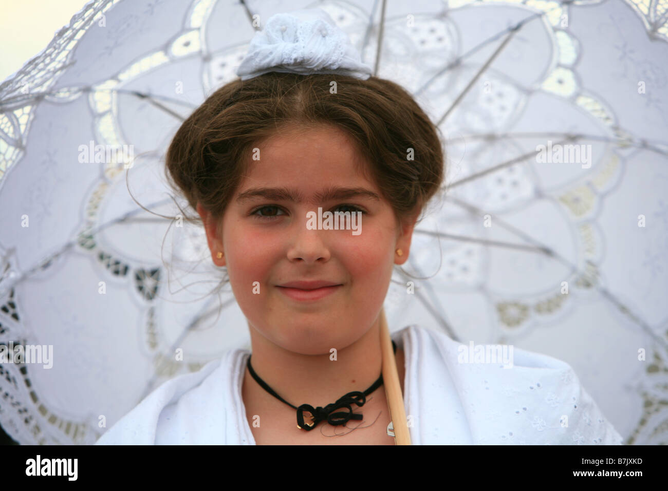 Young girl in traditional dress of the French Provence in Saintes ...