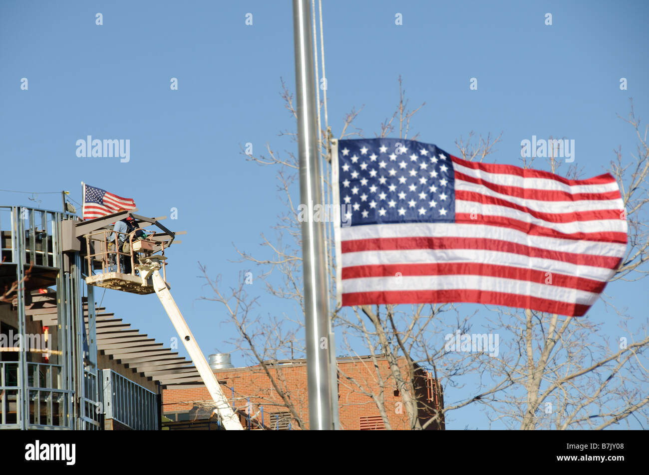 Construction workers an american flag hi-res stock photography and ...