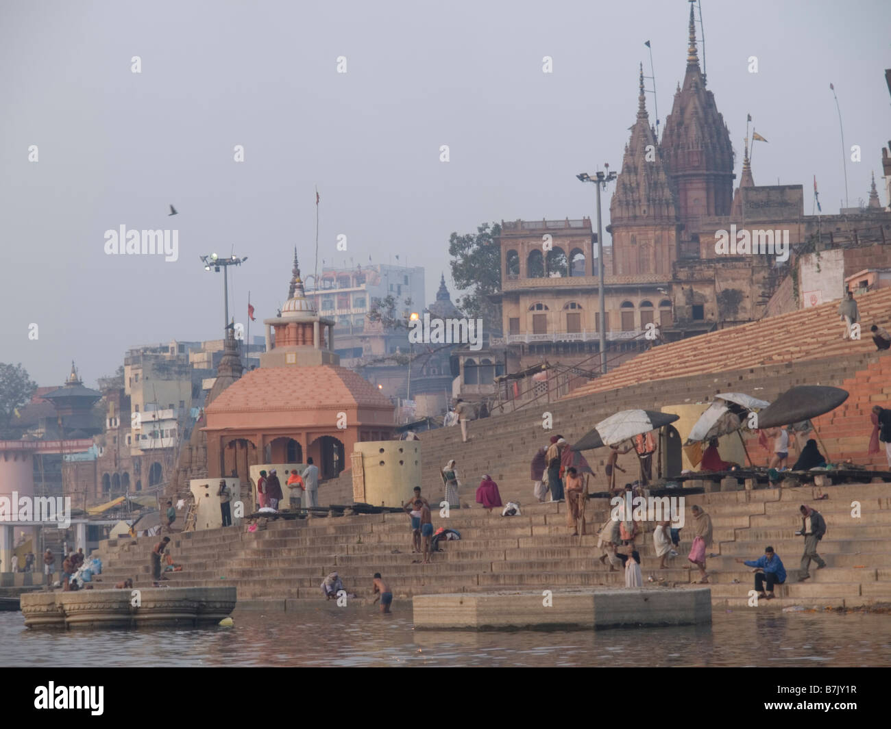 The Ghats is where pilgrims bathe and worship in the holy river Ganges ...