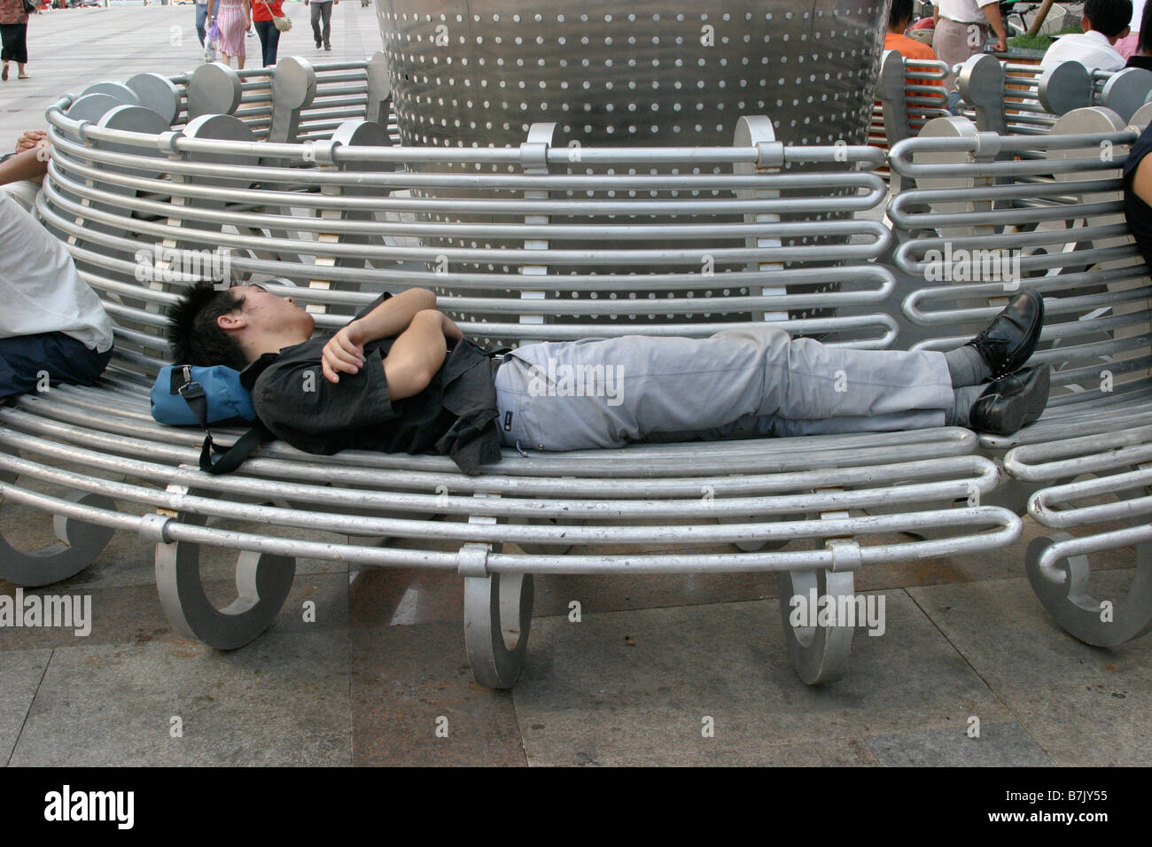 Sleeping Chinese on a street of Shanghai. People take a nap anywhere ...