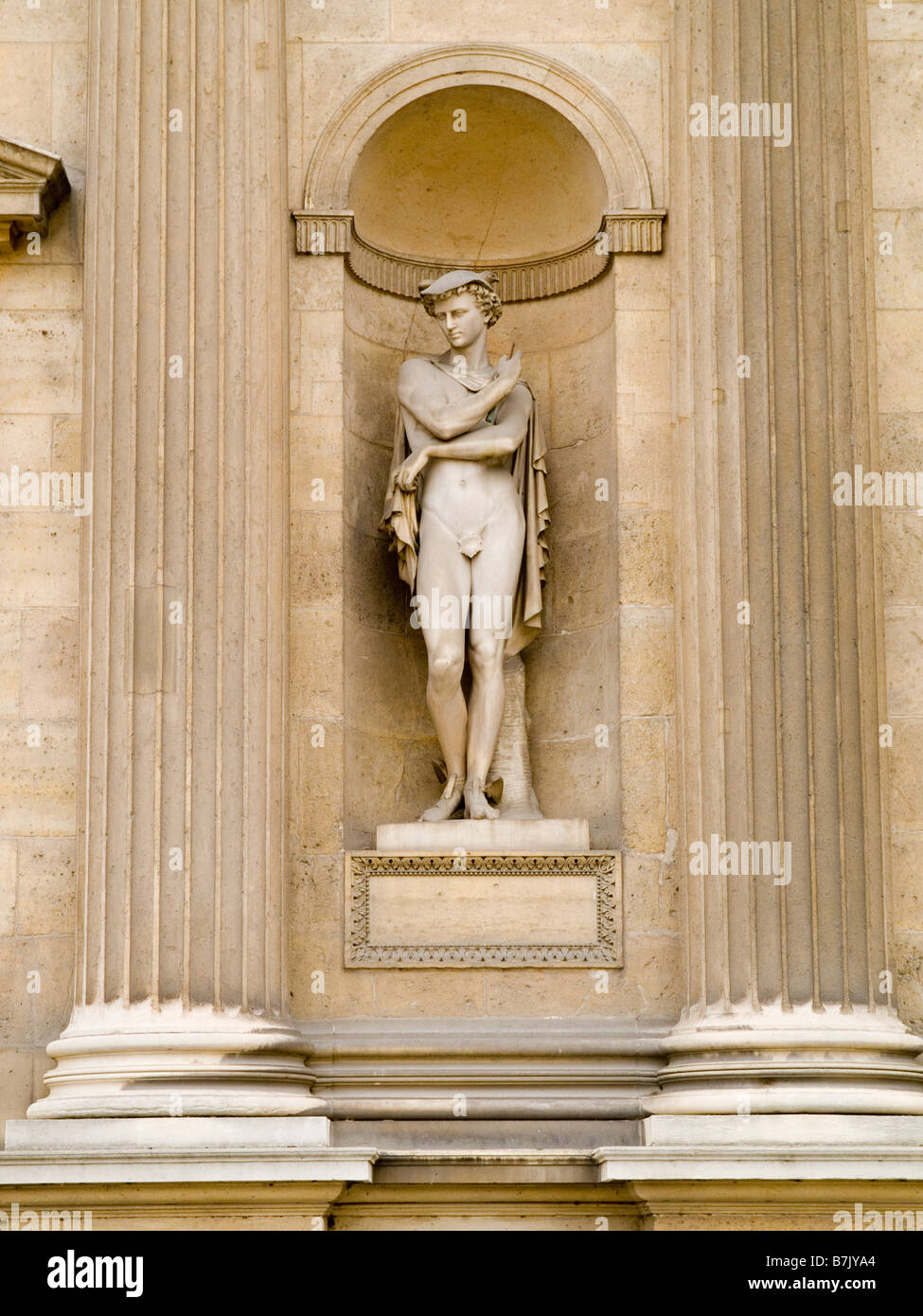 Close up of a stone statue in a recess of the Palais du Louvre (home of ...