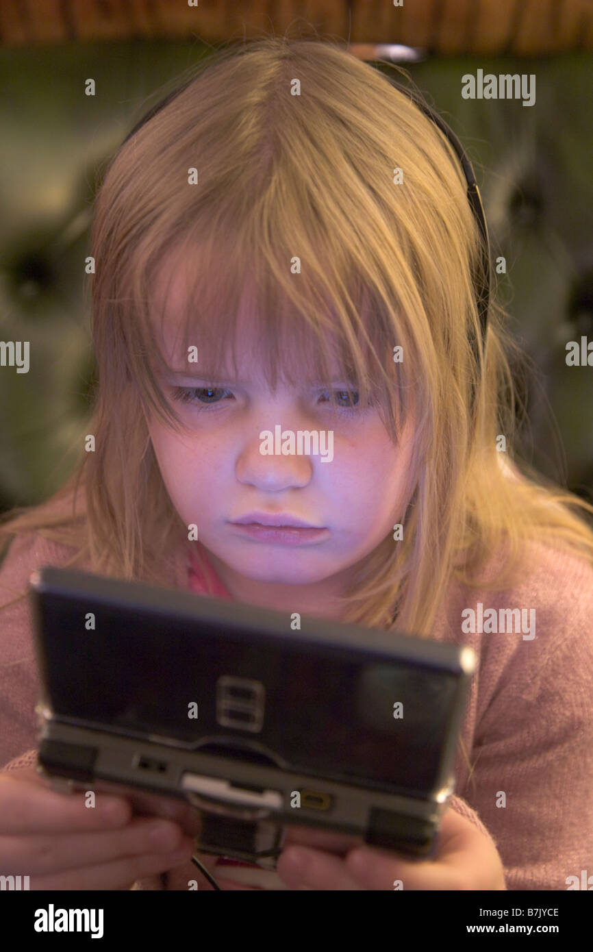 5 year old girl playing Nintendo ds Lite console Stock Photo - Alamy