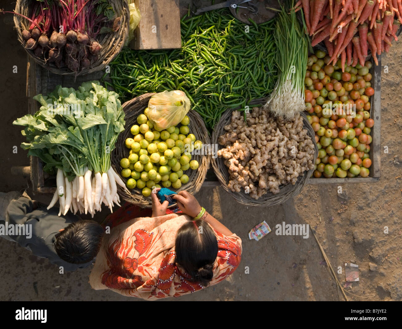 A seller of vegetables in a market Stock Photo - Alamy