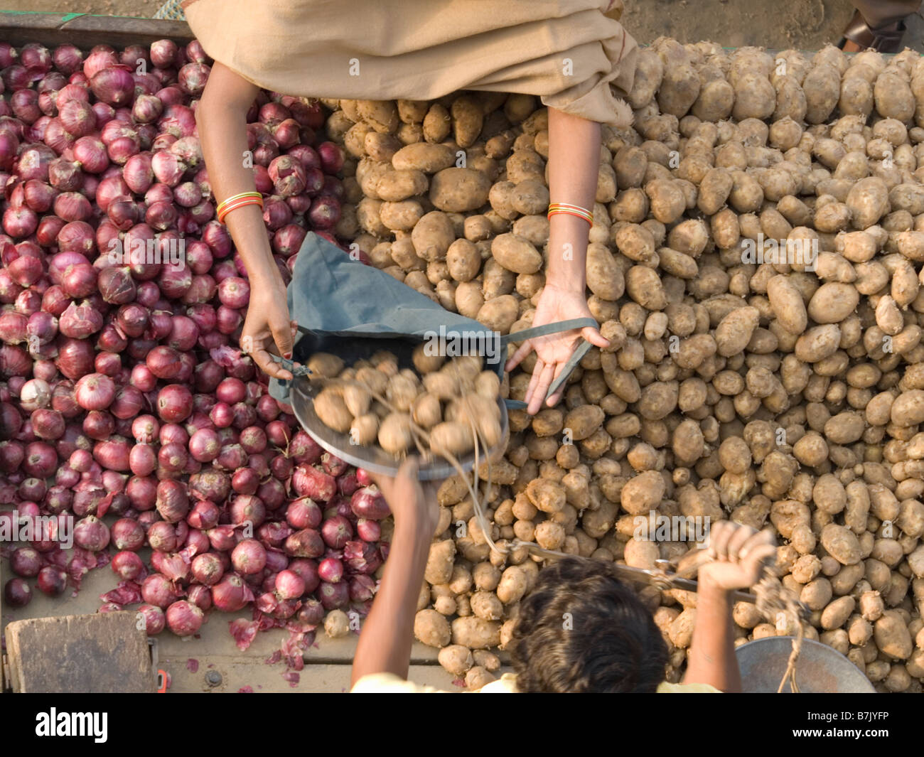 A seller of vegetables in a market Stock Photo - Alamy