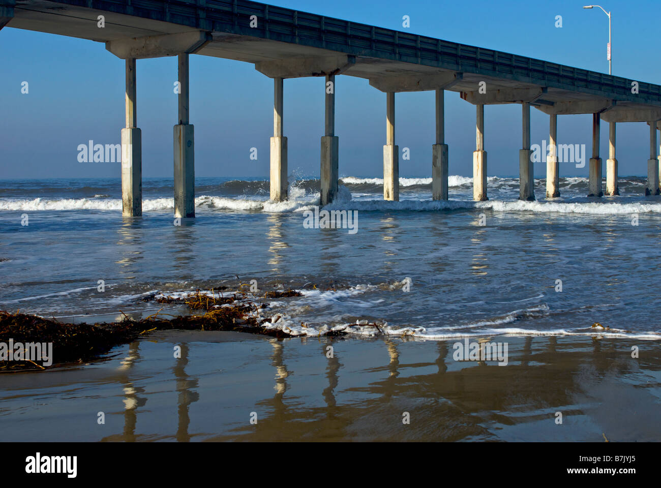 reflection of pier on sand Stock Photo - Alamy
