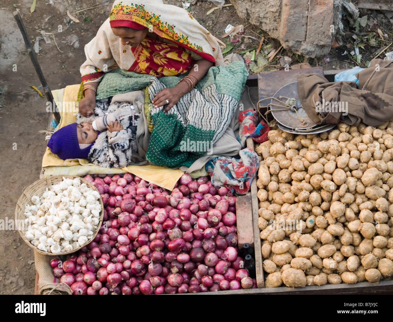 A seller of vegetables in a market Stock Photo - Alamy