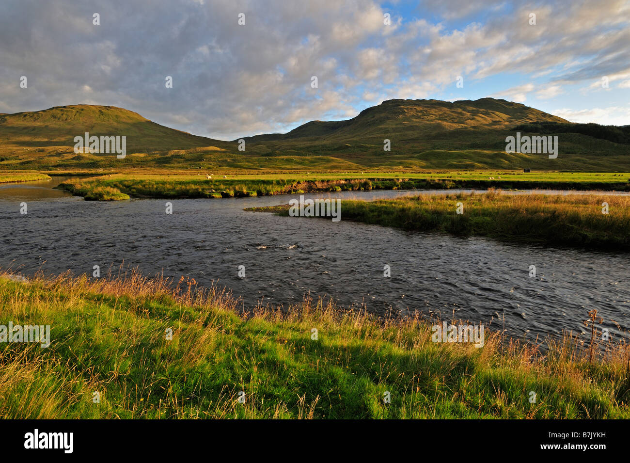 The River Lyon and surrounding fields and hills in warm evening light ...