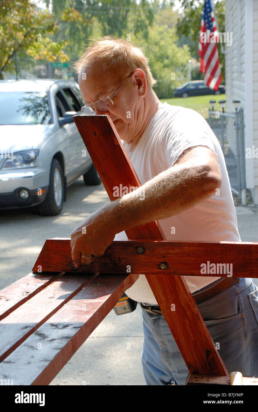 Man putting picnic table back together after being resurfaced Stock ...