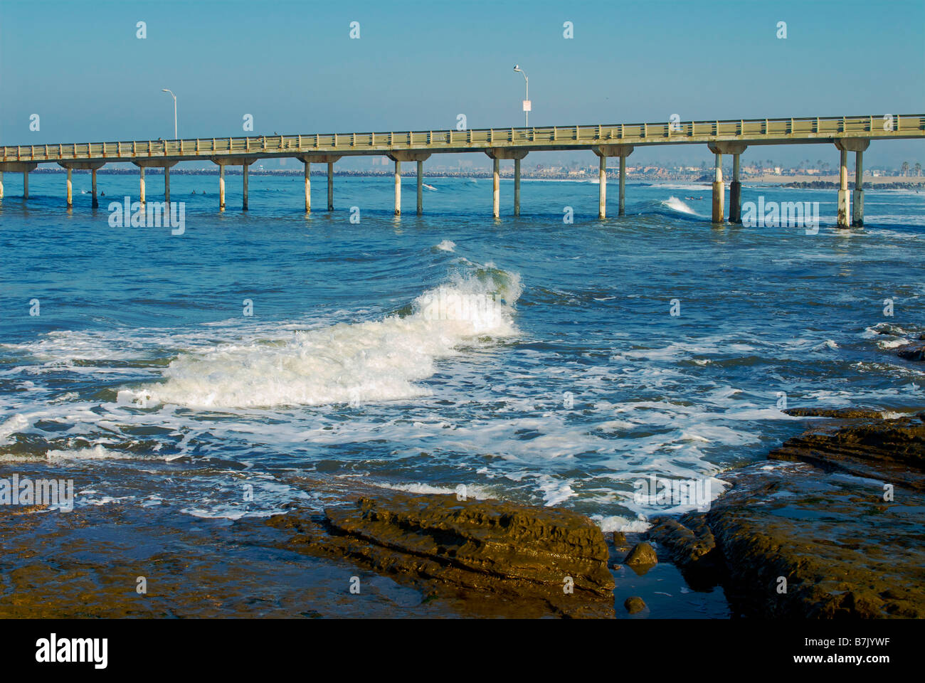 side view of Ocean Beach pier with wave rolling in Stock Photo - Alamy