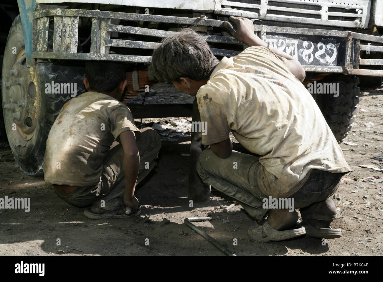 “Small boy and adult working on a bus” Stock Photo - Alamy