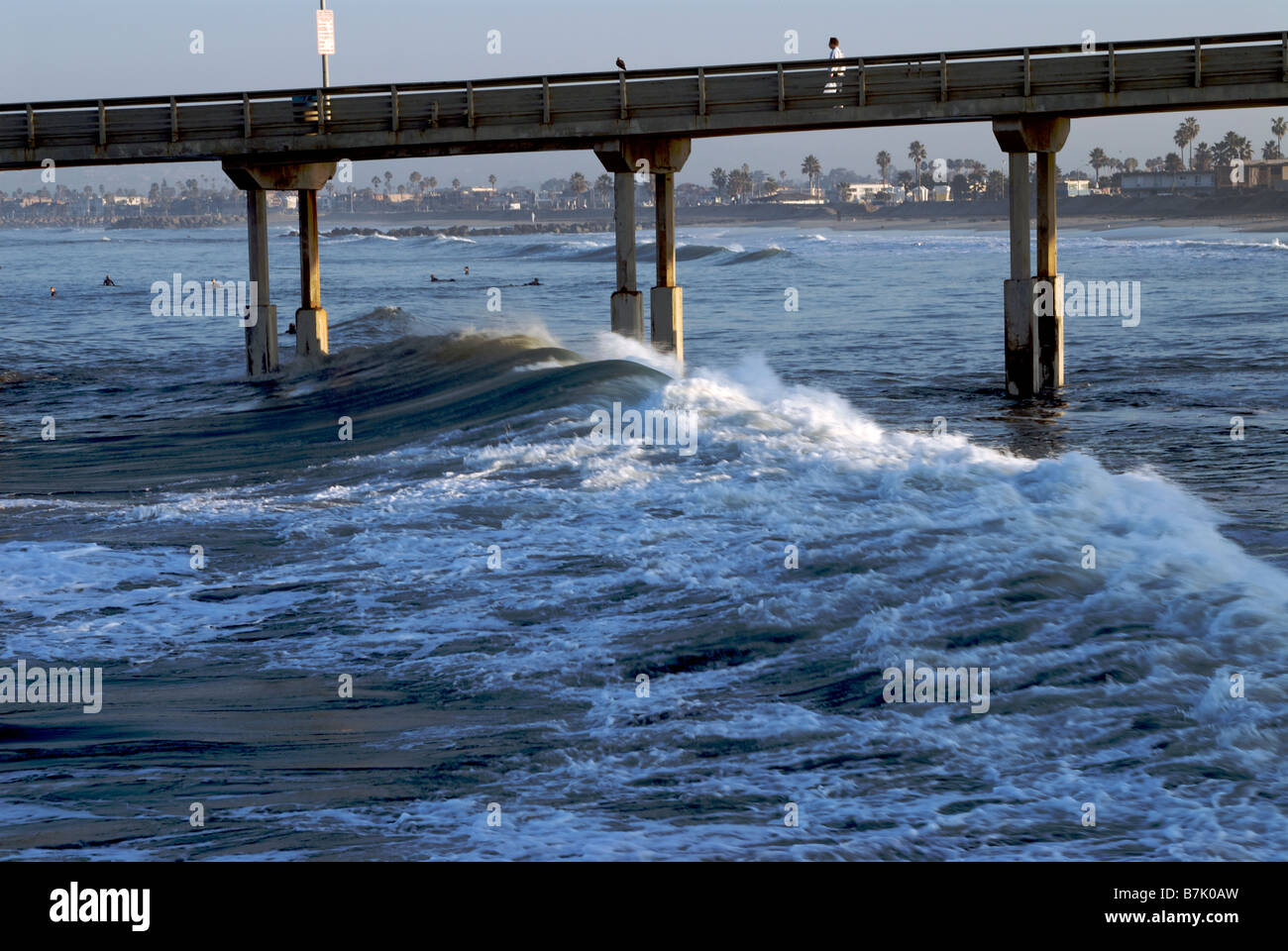 wave breaking under Ocean Beach pier Stock Photo - Alamy