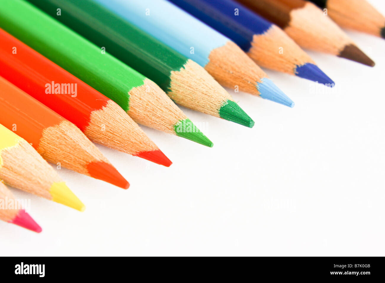 Coloured pencils on a white paper Stock Photo - Alamy