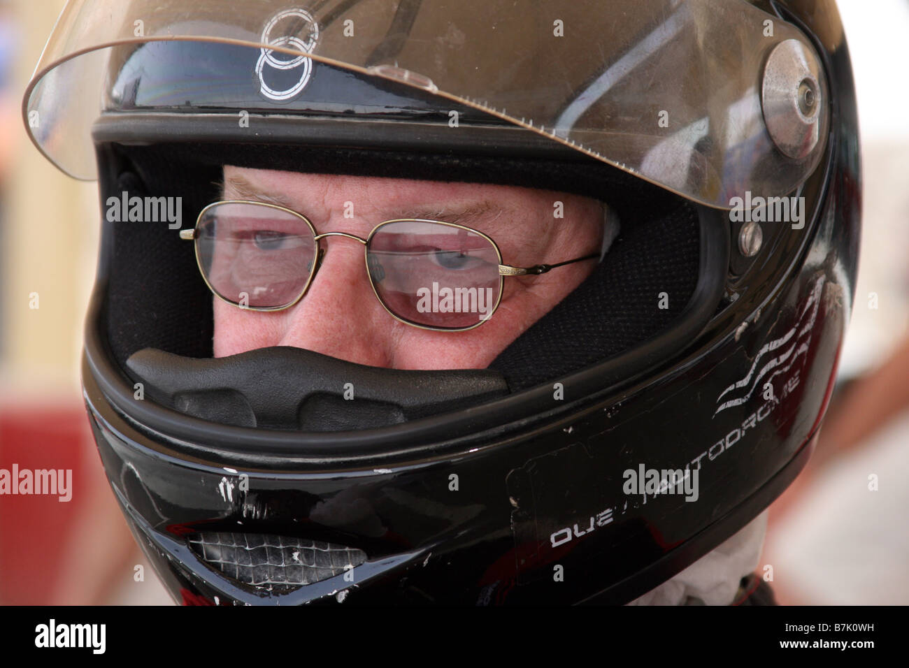 Man in racing helmet Stock Photo - Alamy