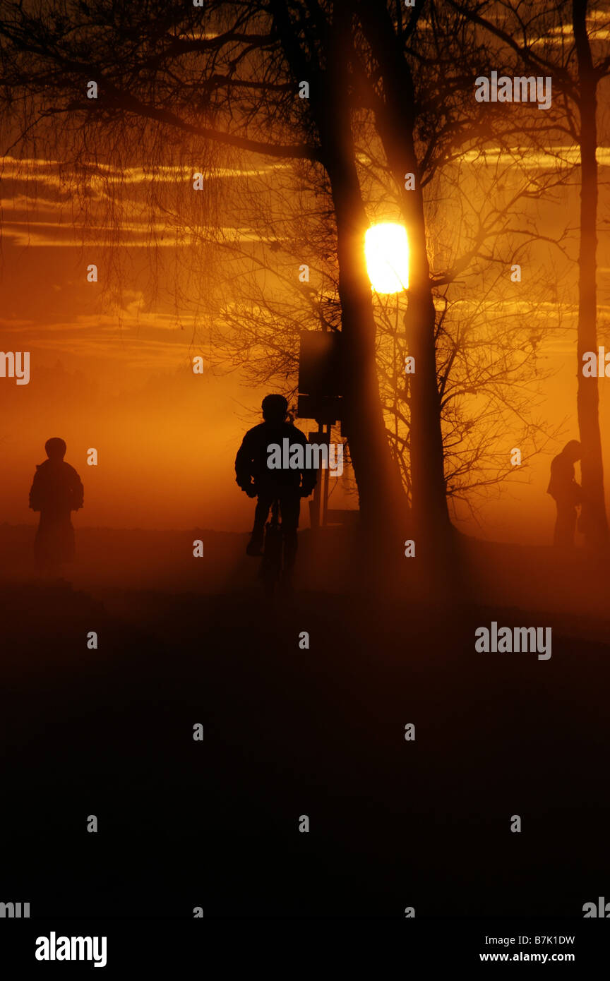 Father and son riding through misty sunset Stock Photo - Alamy