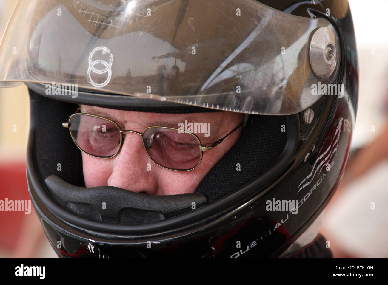 Man in racing helmet Stock Photo - Alamy