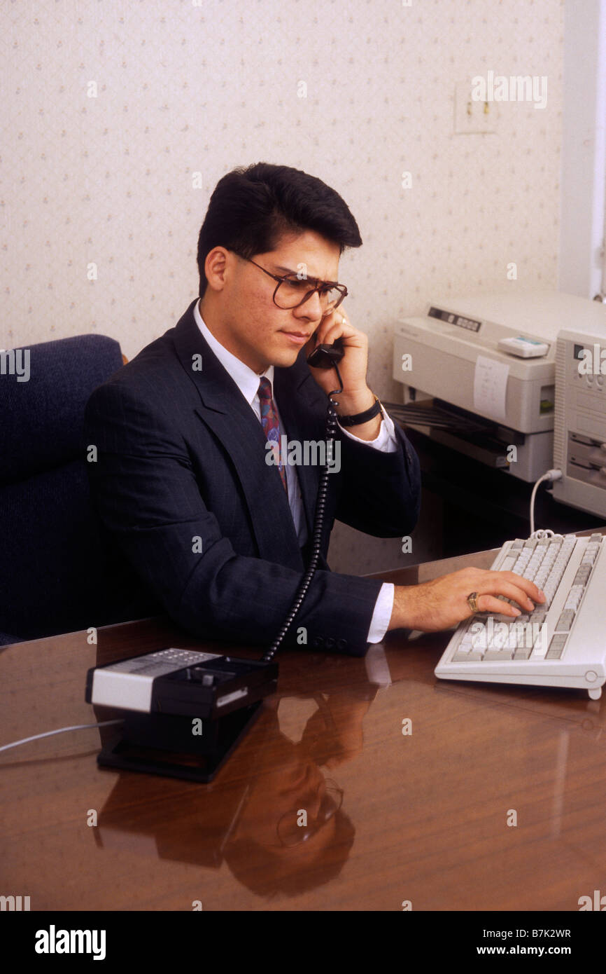 Hispanic male executive works in his office Stock Photo - Alamy
