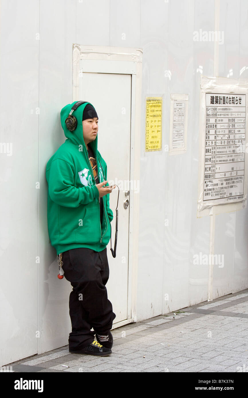 Japanese boy listening to the music on the street, Japan Stock Photo ...