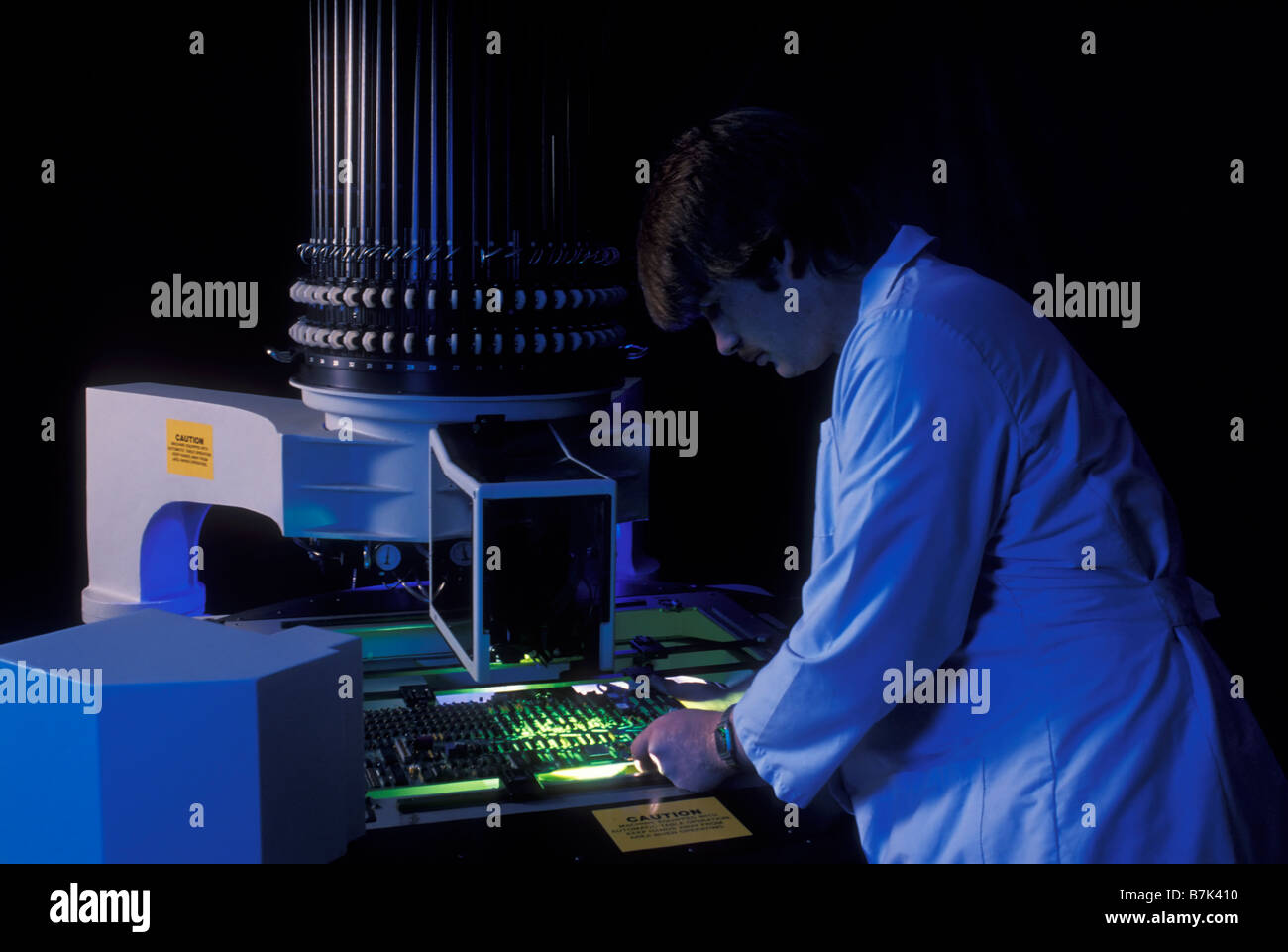 Technician working on chipboard in tech facilty Stock Photo - Alamy