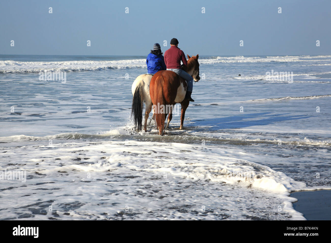 Two people riding horses in water hi-res stock photography and images ...