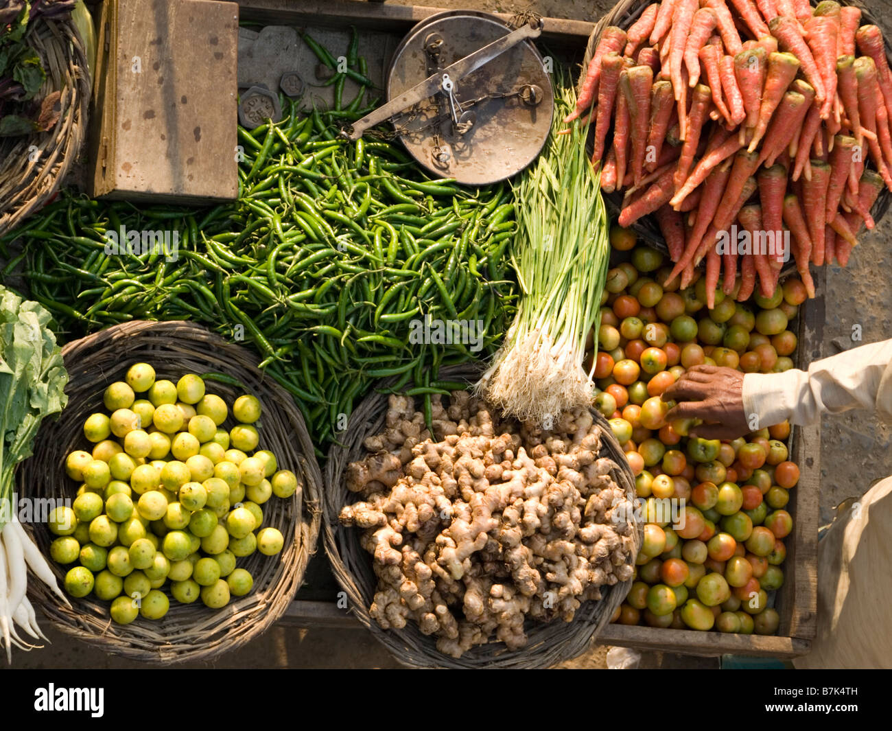 A seller of vegetables in a market Stock Photo - Alamy