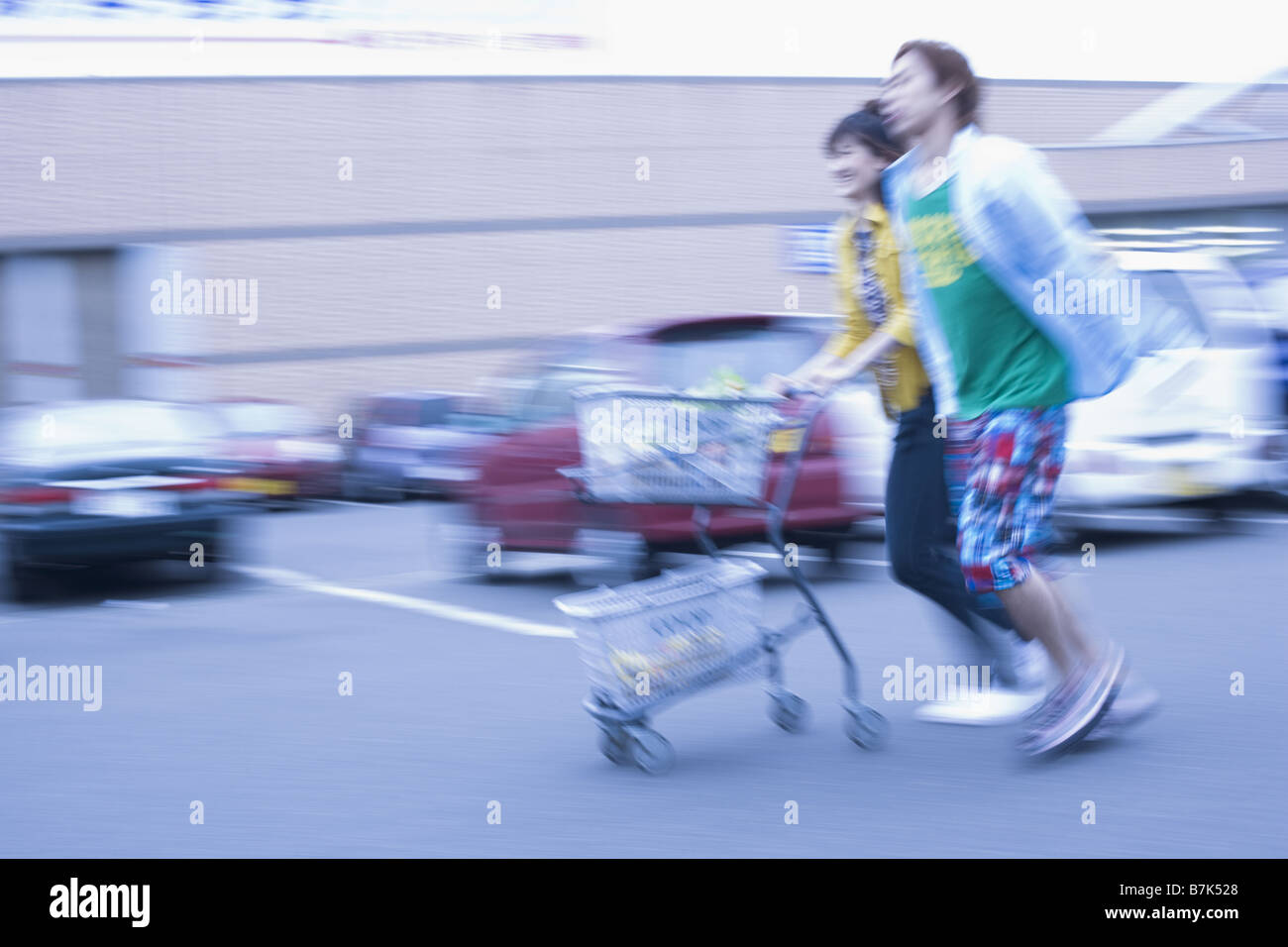Couple Pushing a Shopping Cart,rear view Stock Photo - Alamy