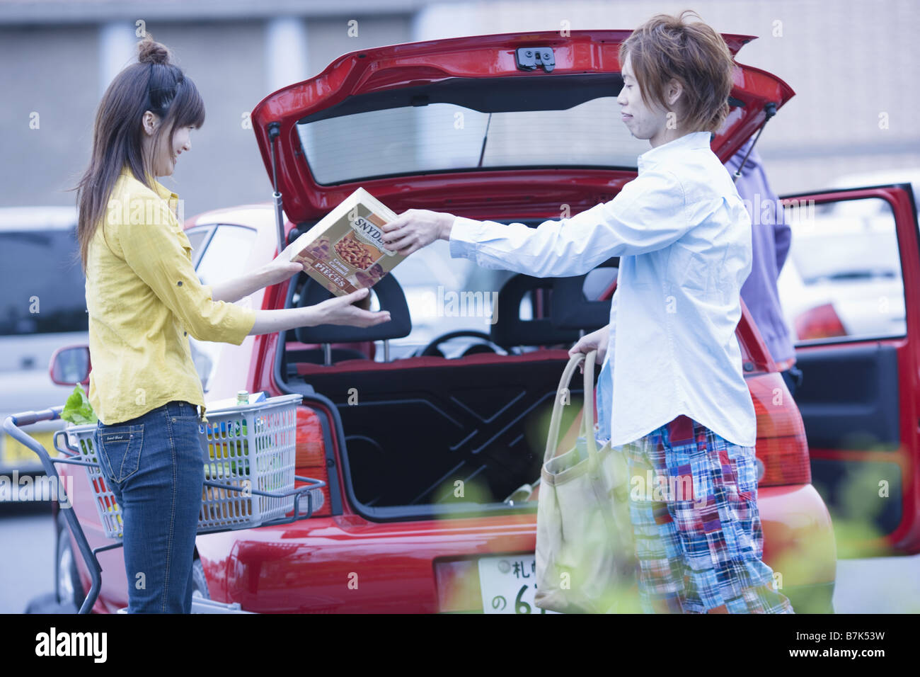 Woman loading car side hi-res stock photography and images - Alamy