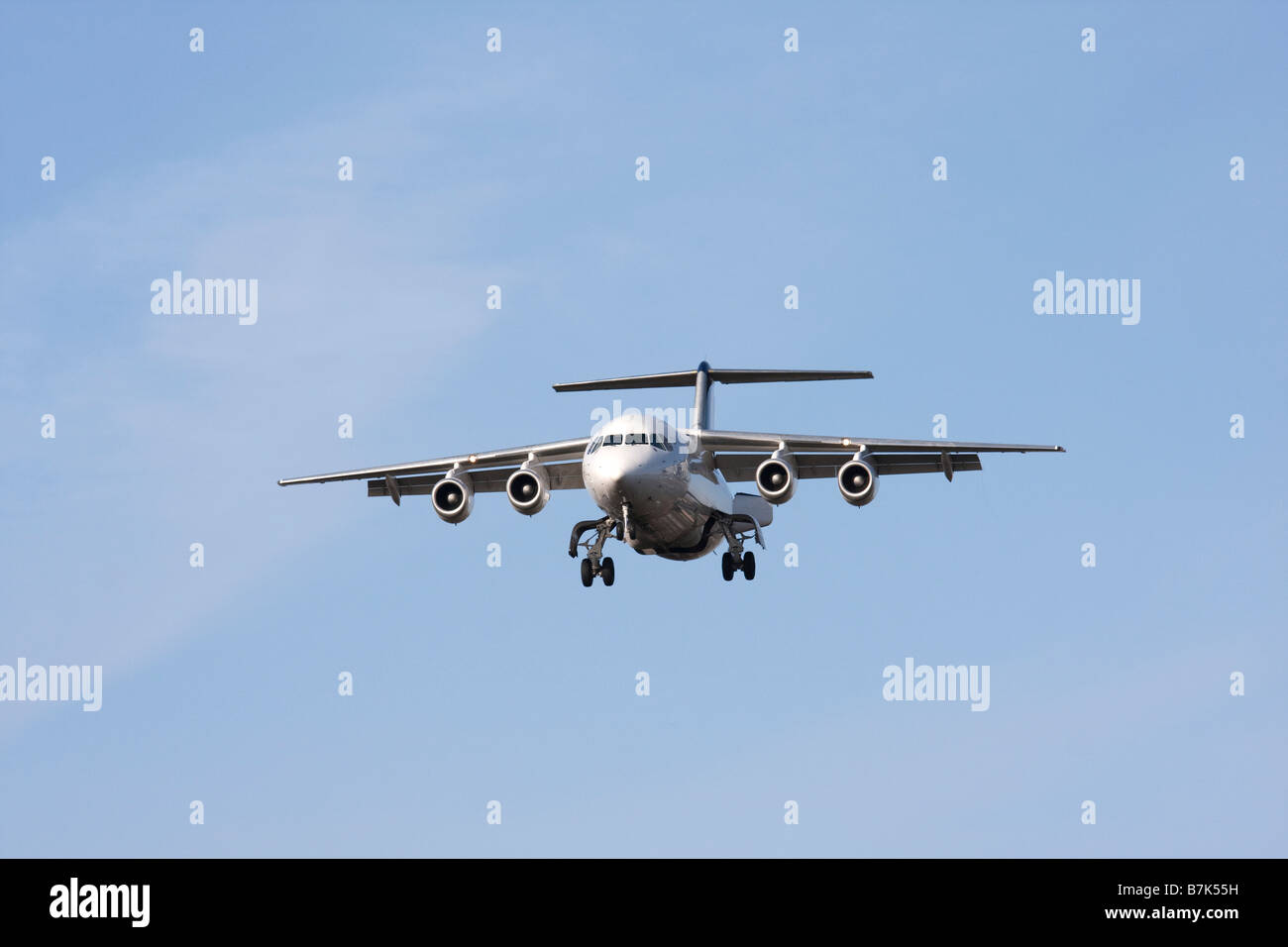 small four engine jet aircraft on final approach to land Stock Photo ...