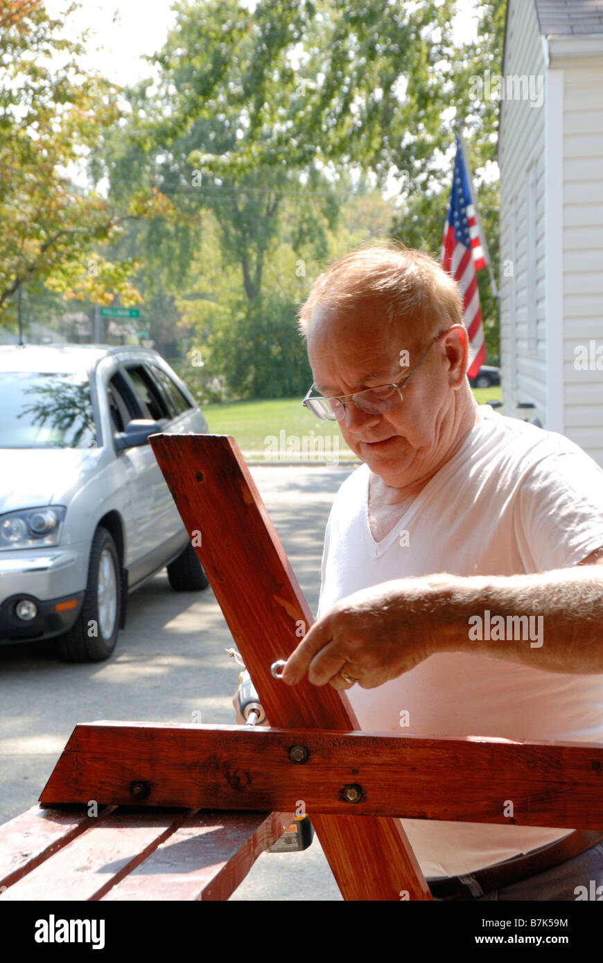 Man putting picnic table back together after being resurfaced Stock ...