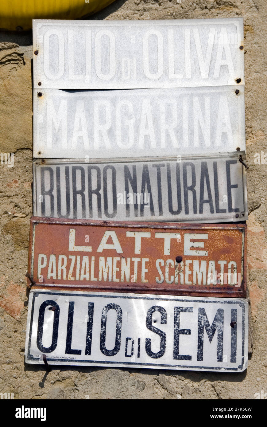 weathered tin sign reading in English: Olive oil, margarine, natural ...