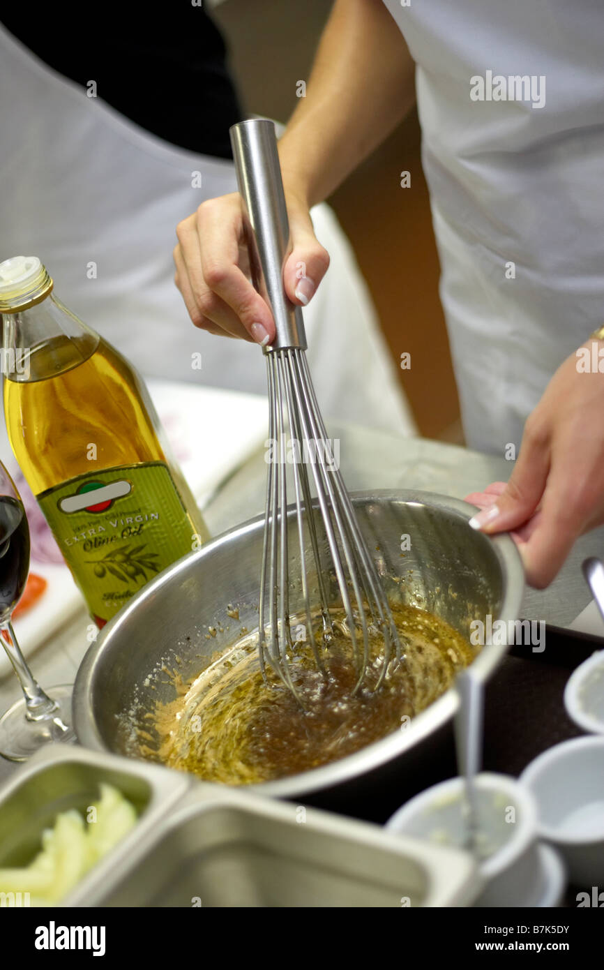 Person whisking bowl of olive oil with herbs and spices Stock Photo - Alamy