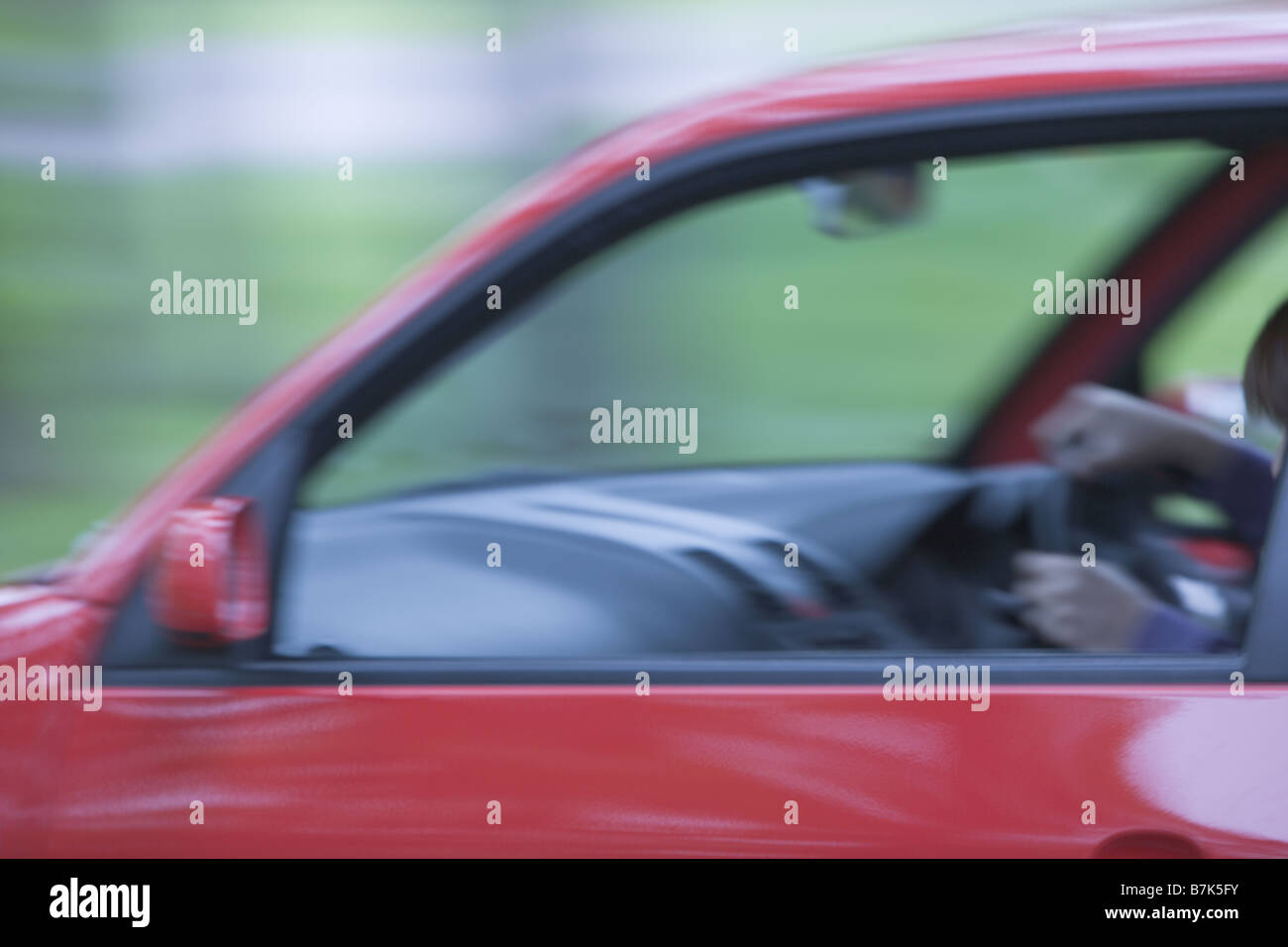 A Red Car on the Move Stock Photo - Alamy