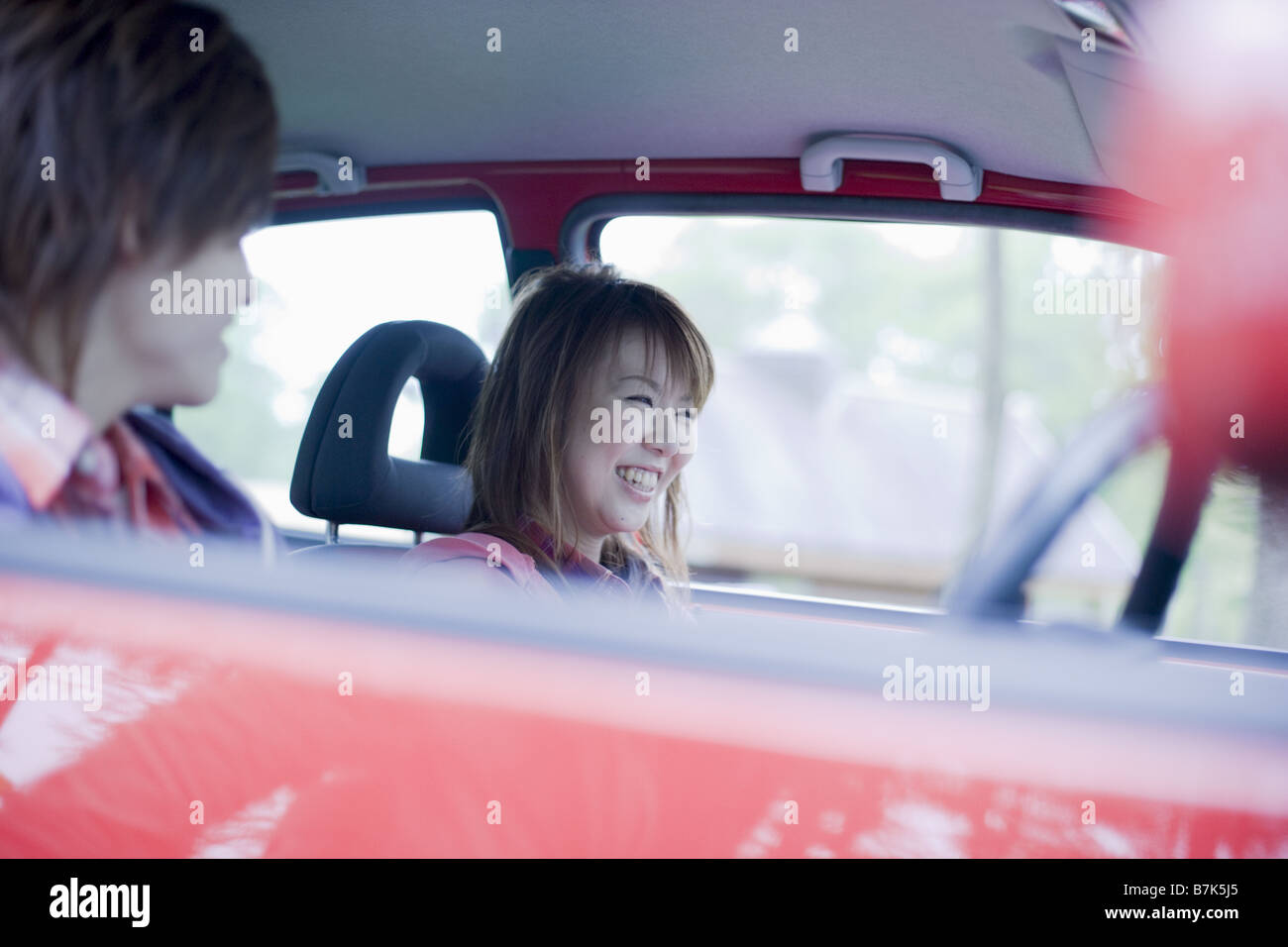 Young Couple Having Chat in a Car Stock Photo - Alamy