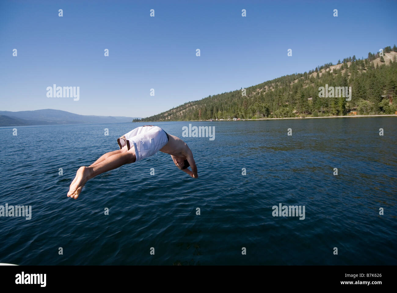 Youth diving into lake, Okanagan Centre, BC Canada Stock Photo - Alamy