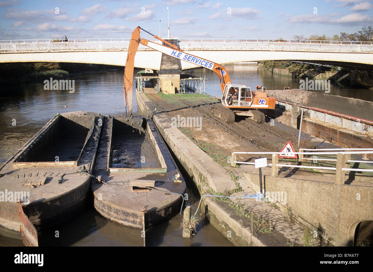London, JCB dredging mud from the River Lea, beside Bow locks Stock ...