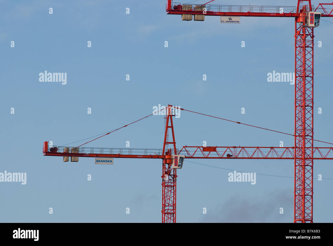 twin tower cranes working on a construction site Stock Photo - Alamy